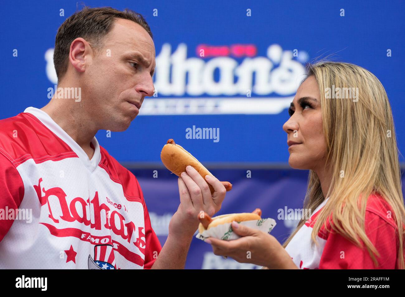 Competitive eaters Joey Chestnut, left, and Miki Sudo, right, face off ...