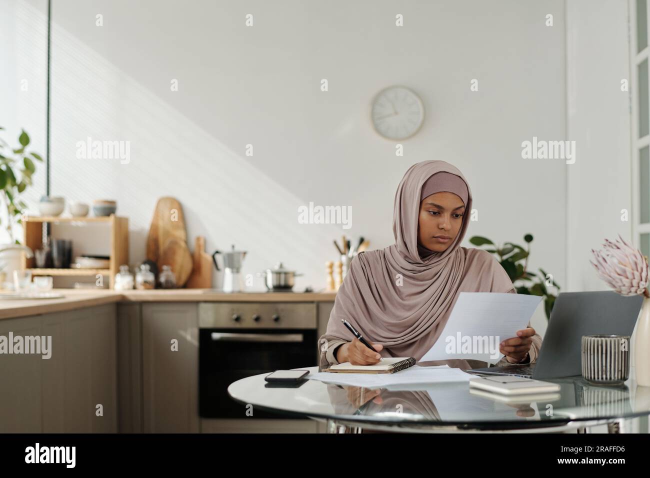 Serious female auditor with business document looking through its main ...