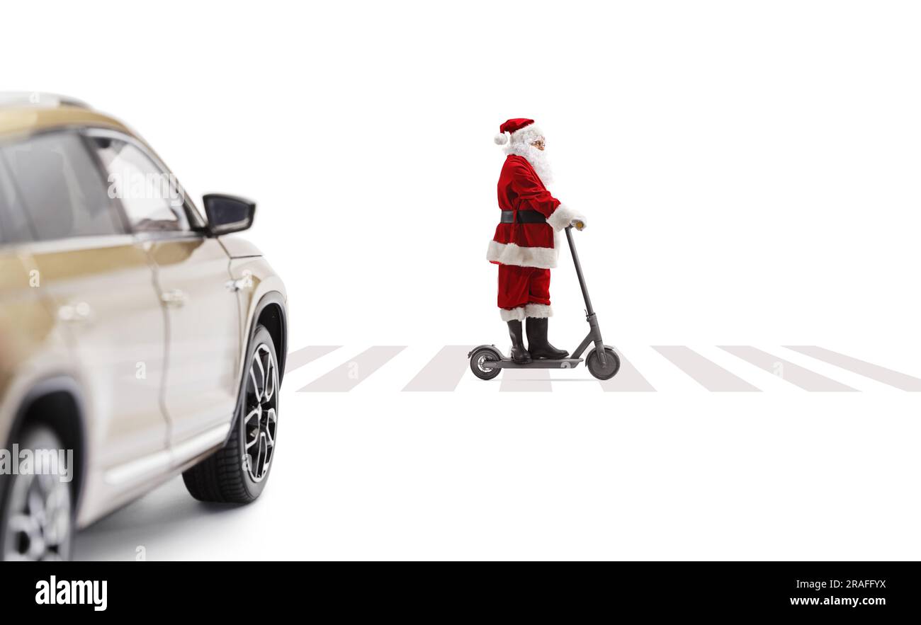 Santa Claus riding an electric scooter at a pedestrian crossing ...