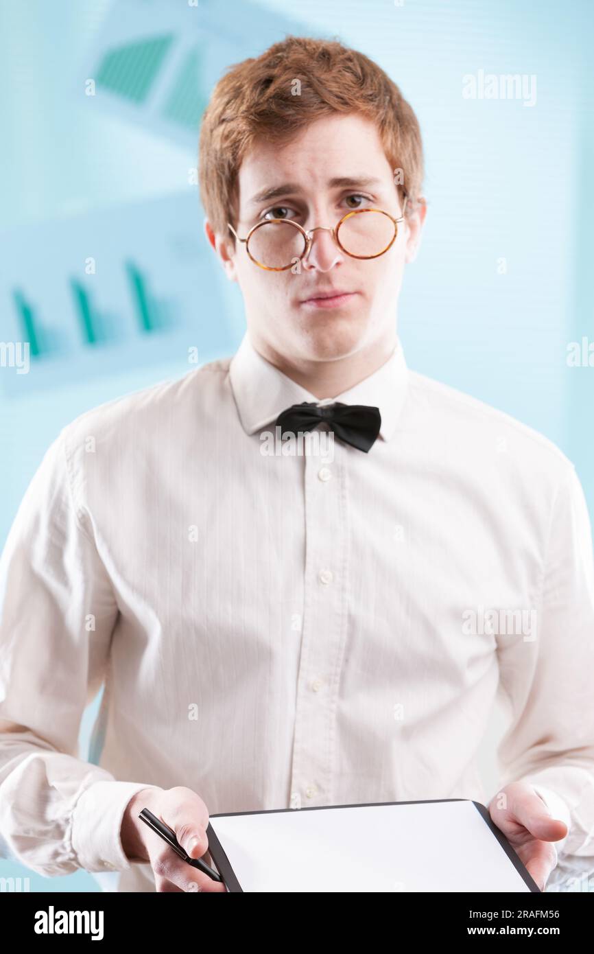 A somewhat nerdy, slightly subservient young man in a dated office suit ...