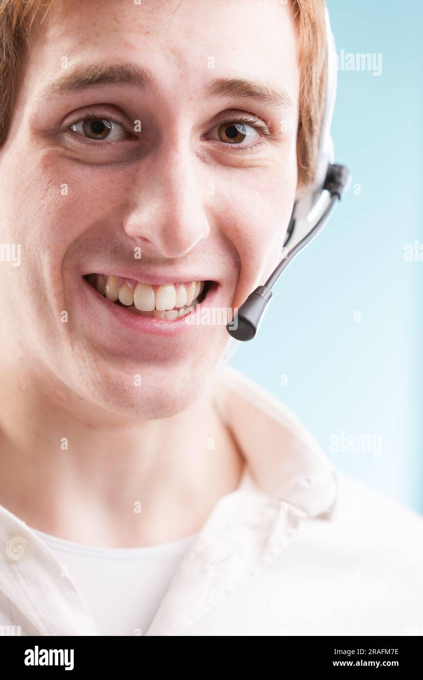 Call center worker in white shirt, amidst blurred background of ...