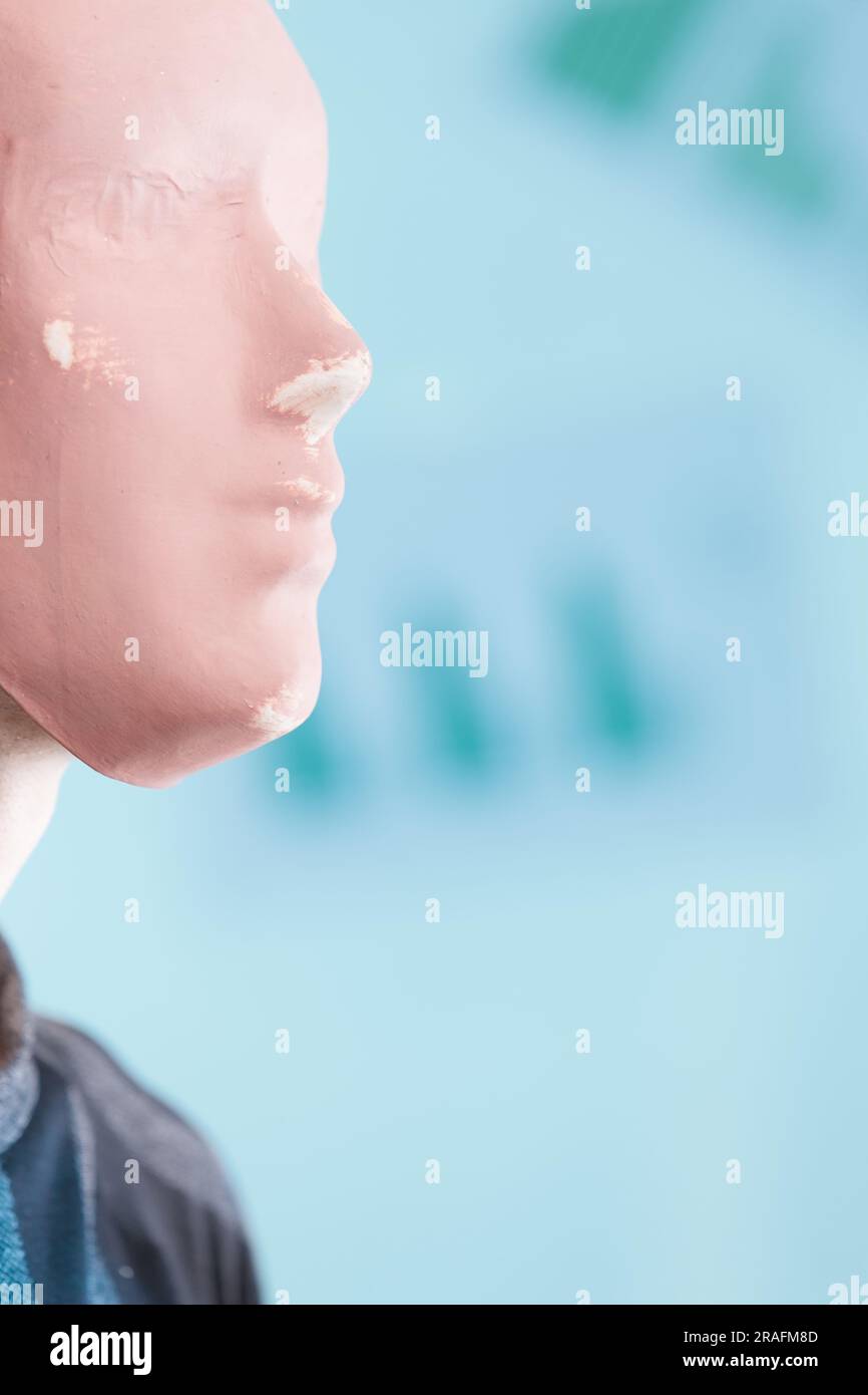 man with a blank mask, disconnected from reality, symbolises the ...