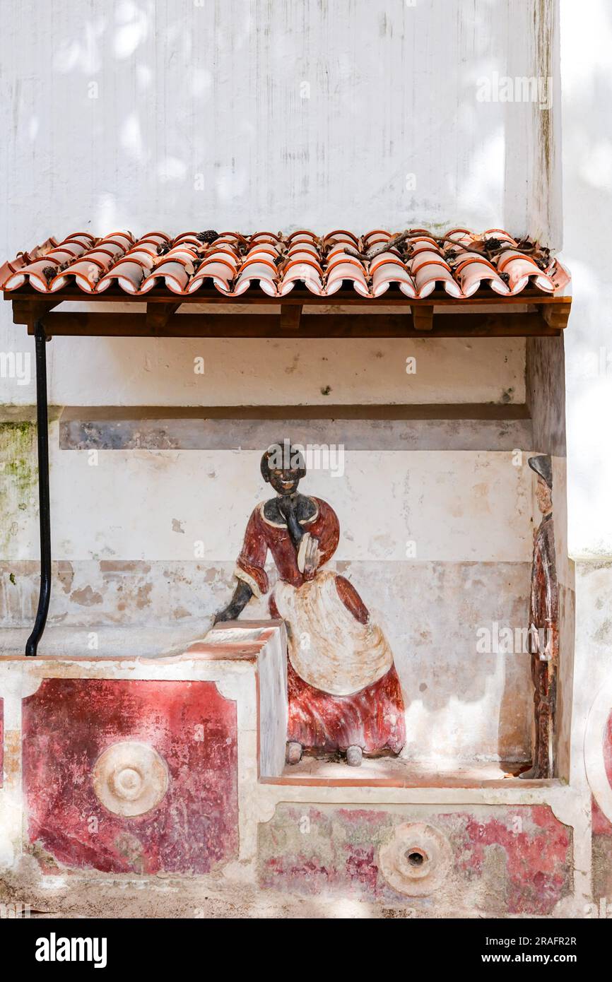 A high relief painting of a black laundry women at the terraced Preta ...