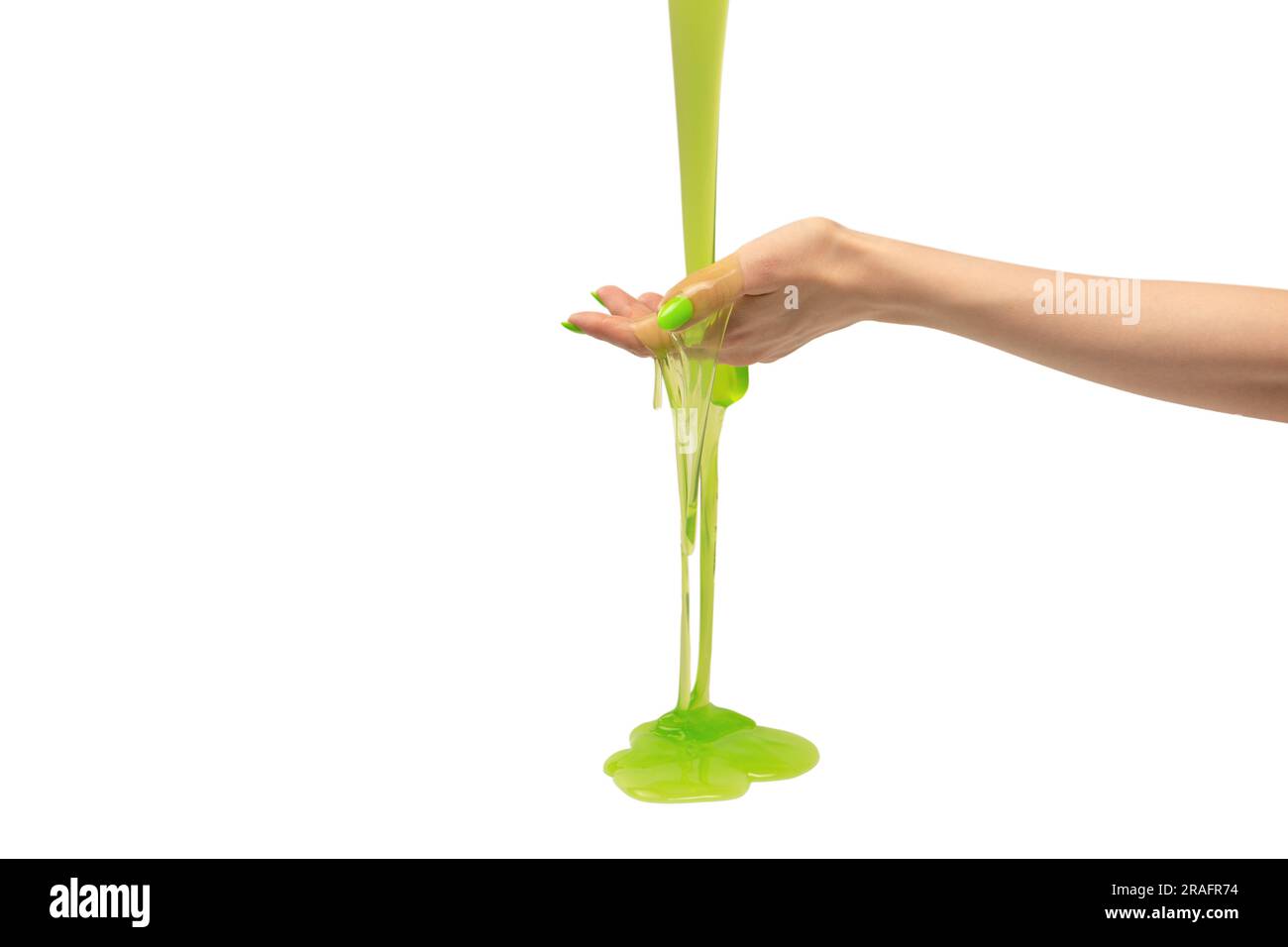 Green slime toy in woman hand with green nails isolated on a white ...
