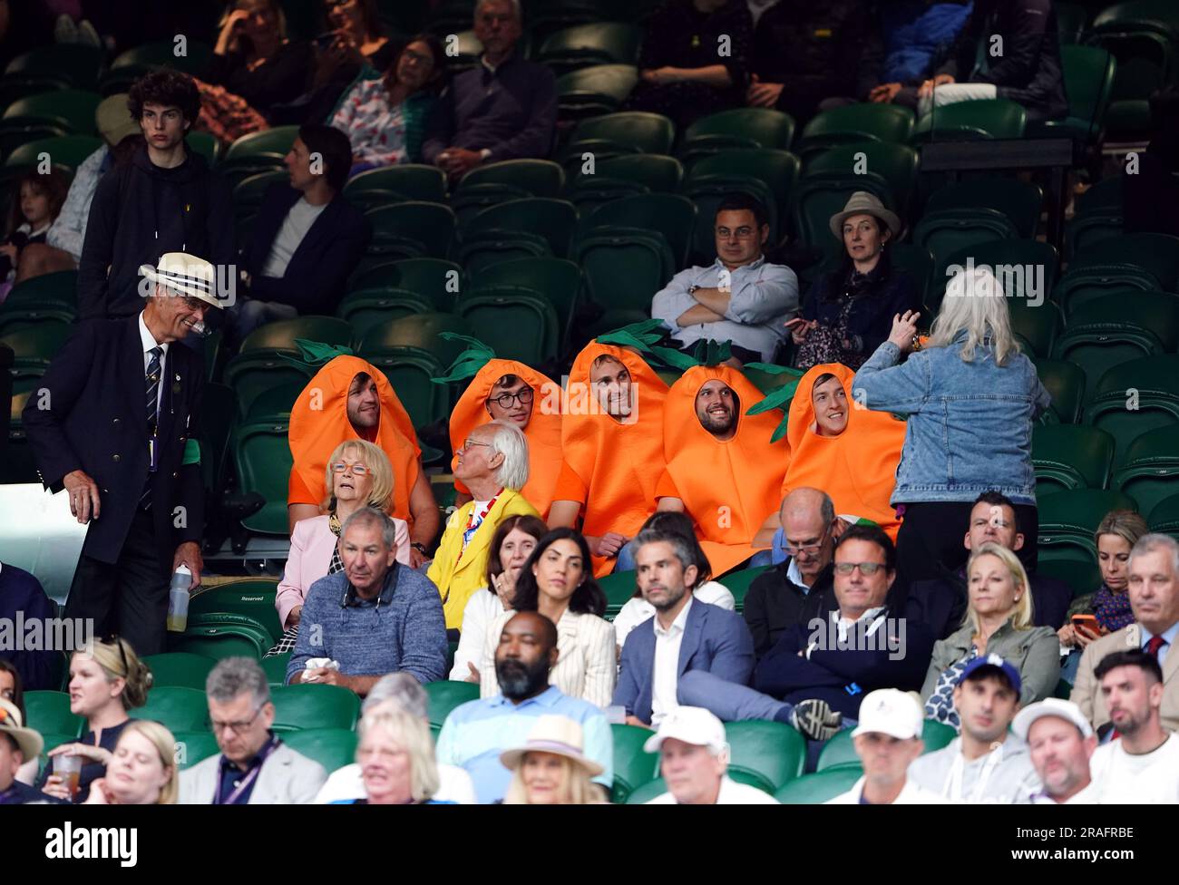 Spectators dressed as carrots, who are supporting Jannik Sinner during ...