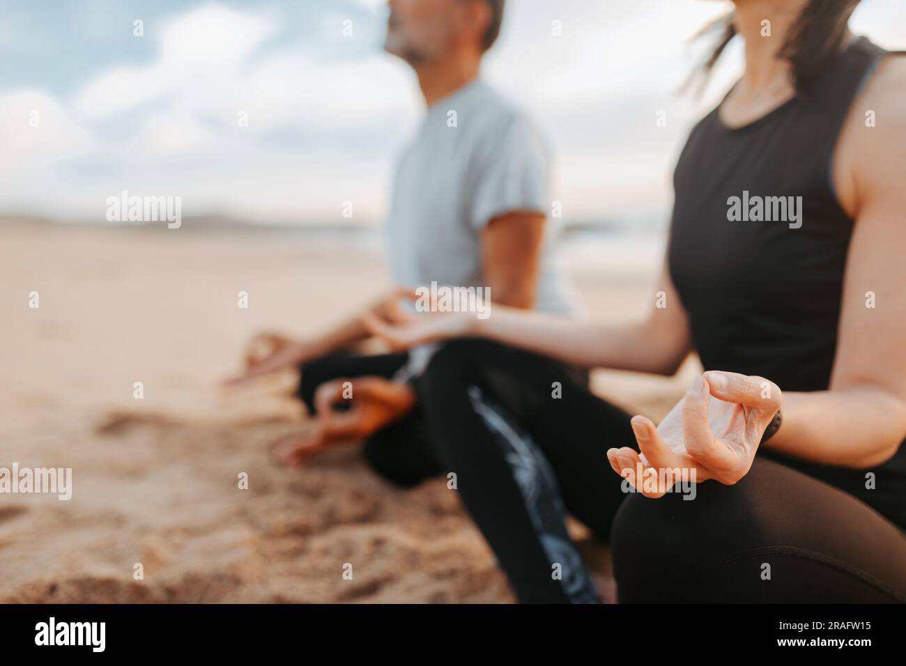 Calm senior caucasian couple in sportswear practice yoga and breathing ...