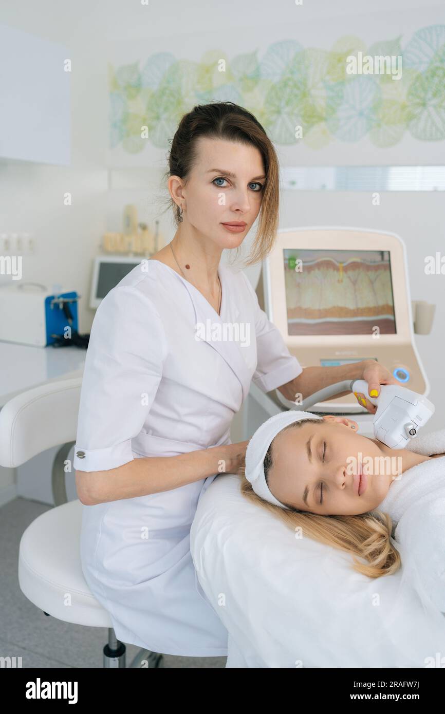 Vertical Portrait Of Beautician Doctor Using Laser Machines And Ultrasound Smas Lifting To