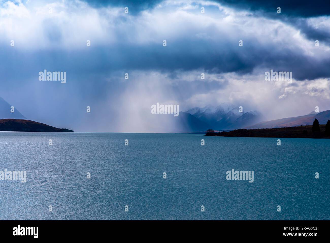 Photograph of early morning sun shining through rain clouds on Lake ...