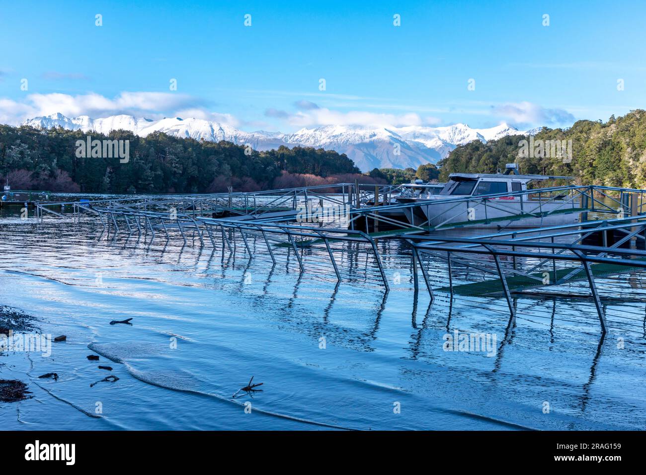 Photograph of snow-capped mountains and flood waters in the Waiau River ...