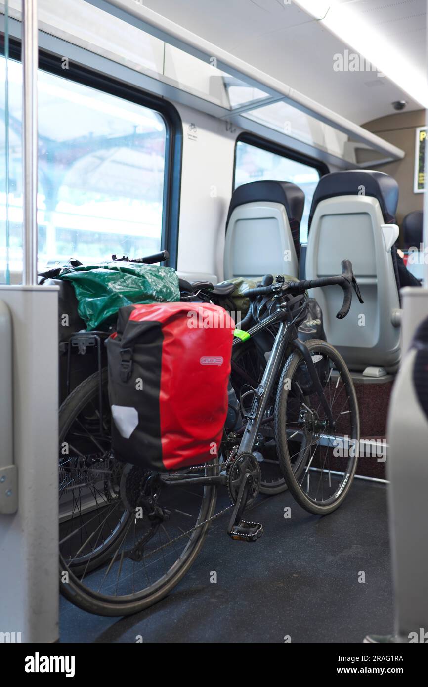 Bicycles on a commuter train in the UK in bike parking space on a busy ...