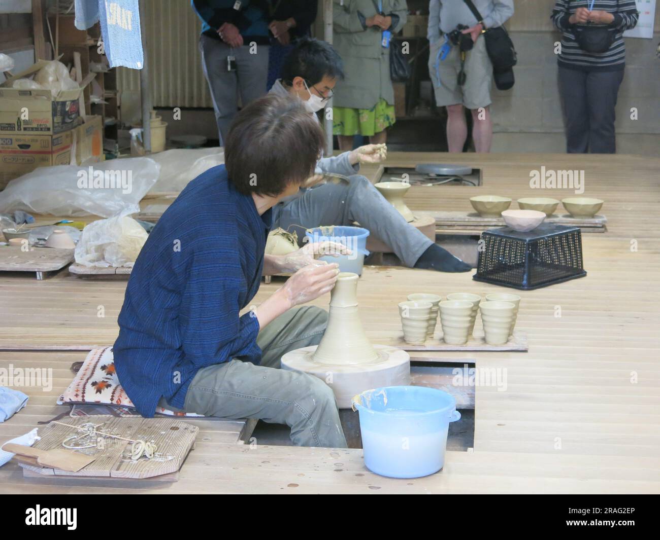 Skilled master potters at their wheels making the Japanese Hagi Ware at ...