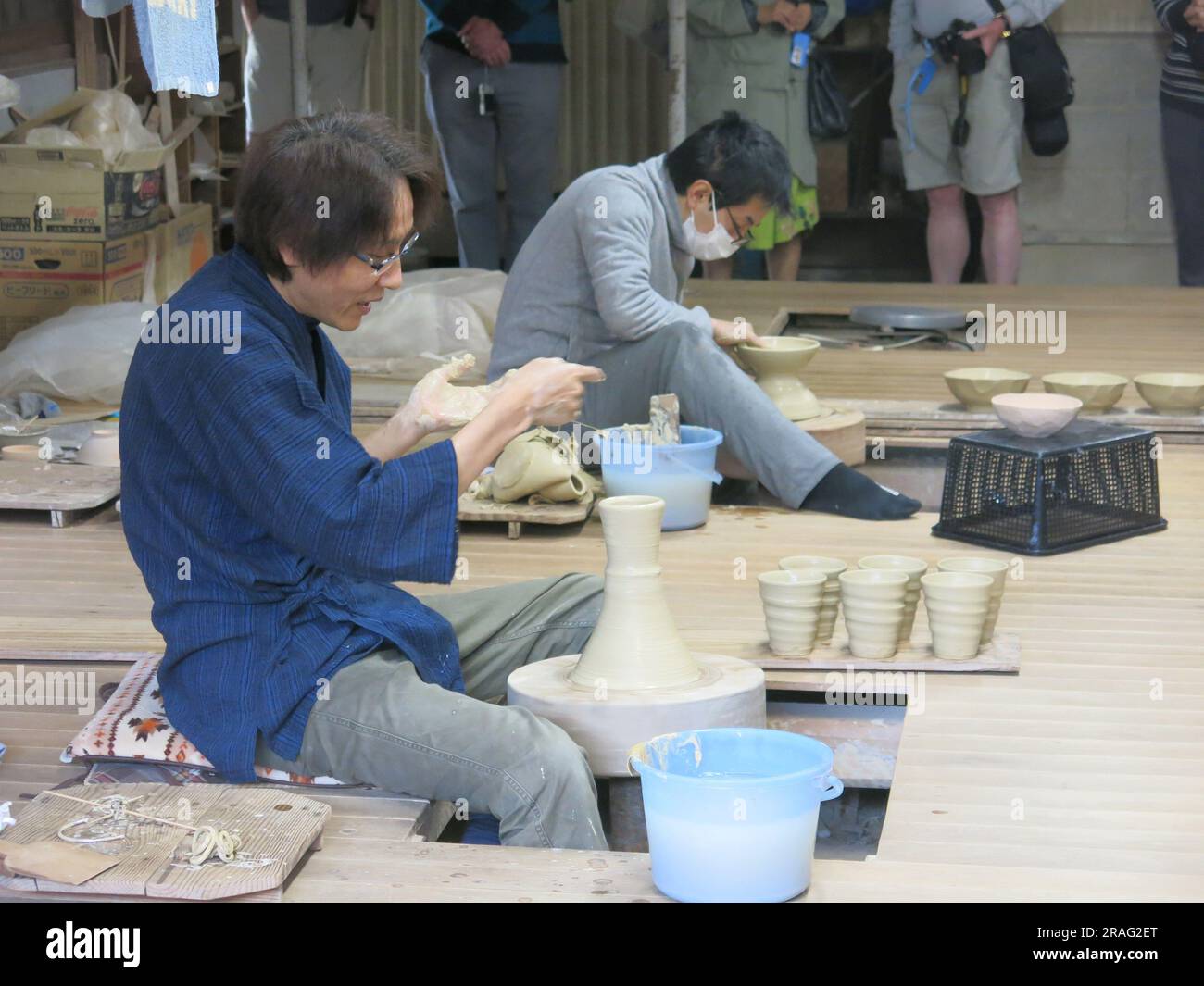 Skilled master potters at their wheels making the Japanese Hagi Ware at ...