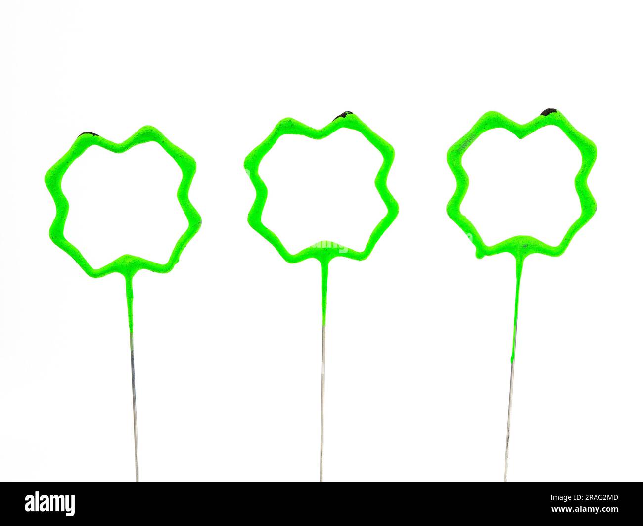 Green sparklers. Bengal fire on a white background. Bengal fire close up Stock Photo - Alamy