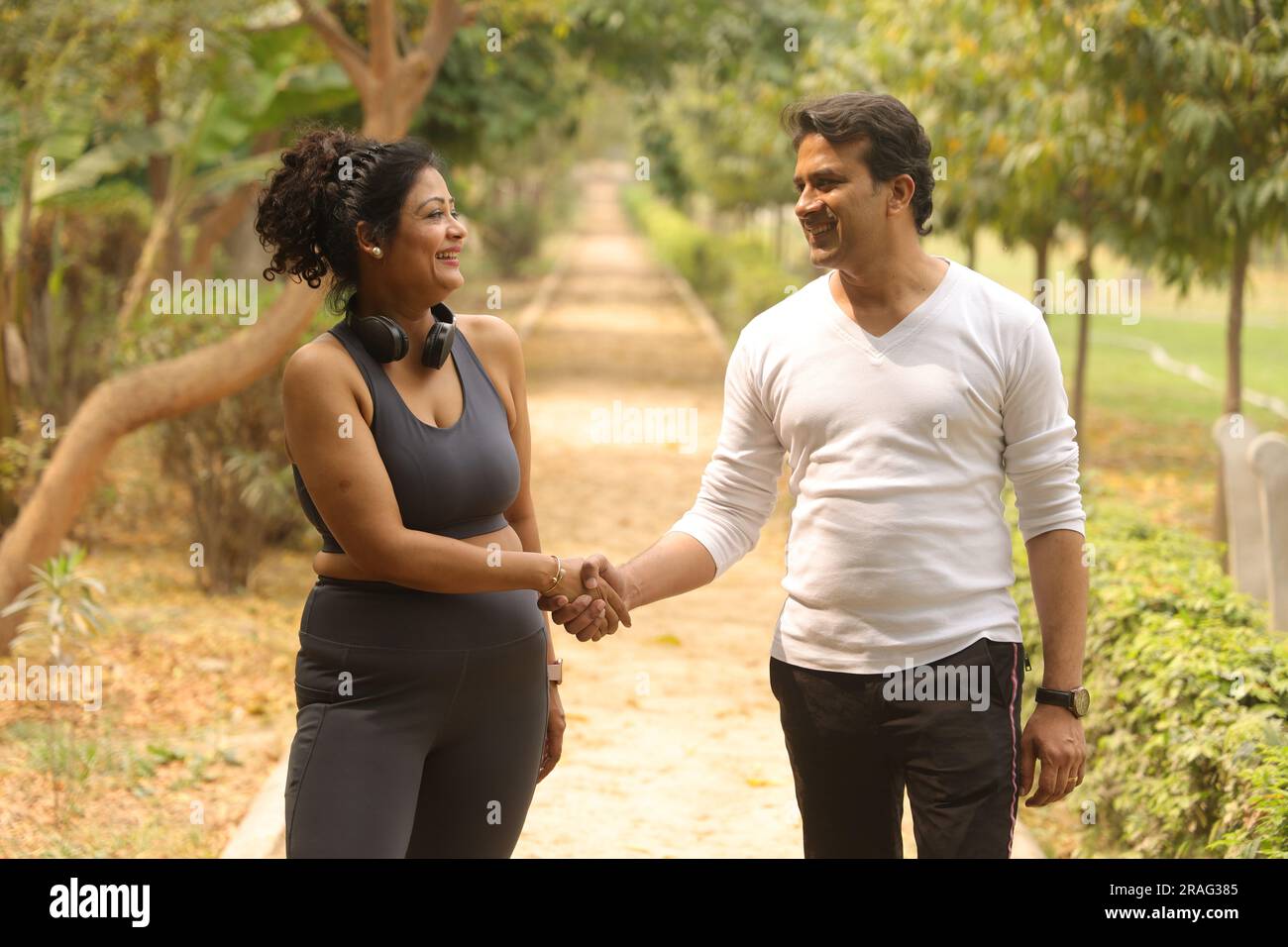 health conscious people and friends cheering up while jogging. They are ...