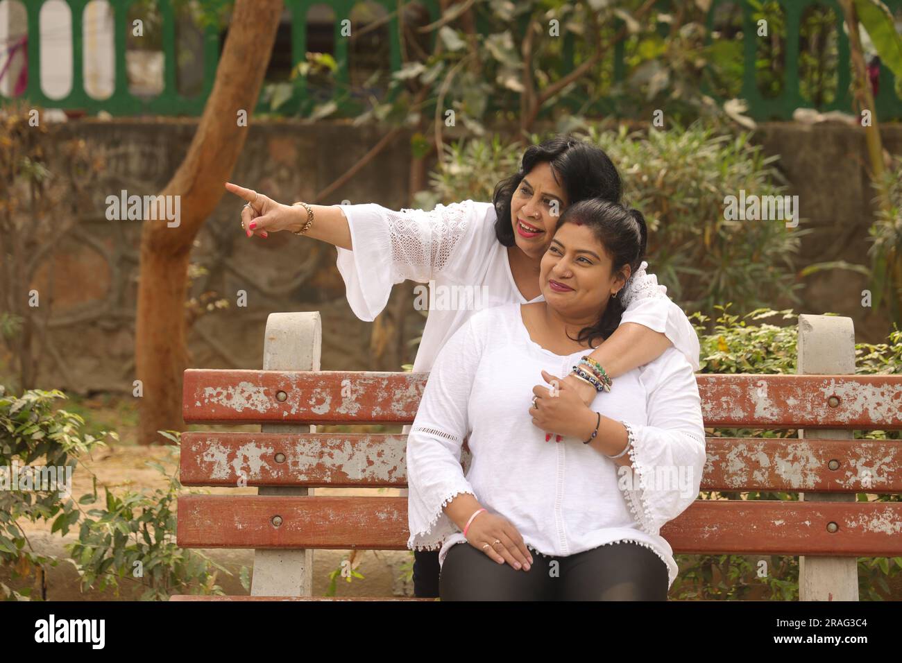 Happy Indian Mother And Daughter In White Dress Having Beautiful