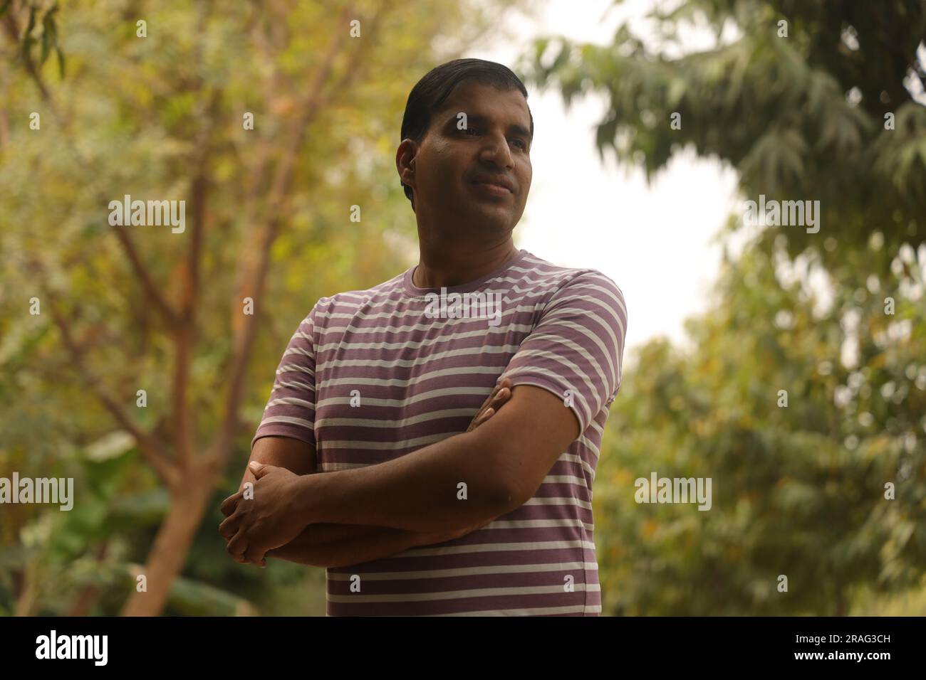 Happy Indian Old man jogging in the park on a Jogging track and trail ...