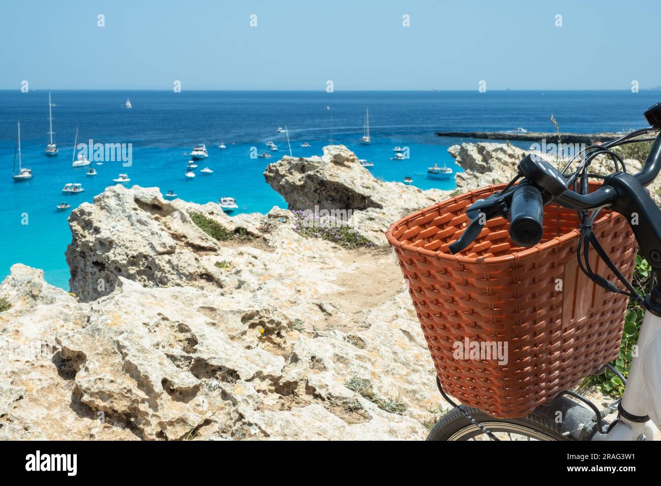 Bike on the top of the rock cliff and Cala Rossa Beach, Sicily Italy ...