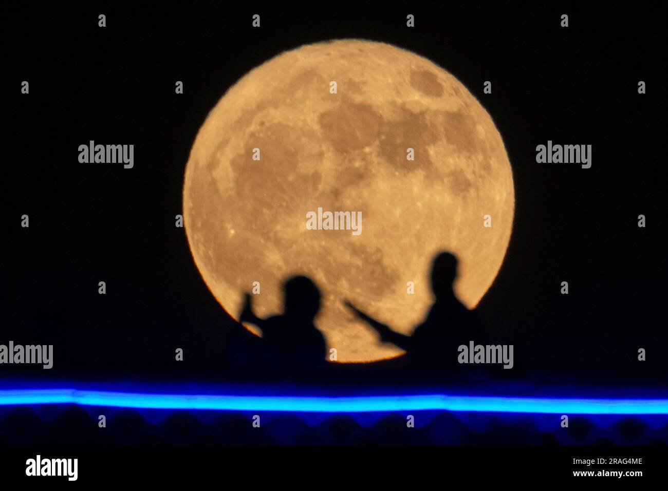 A couple takes pictures on the Al-Shuhada'a bridge over the Tigris ...