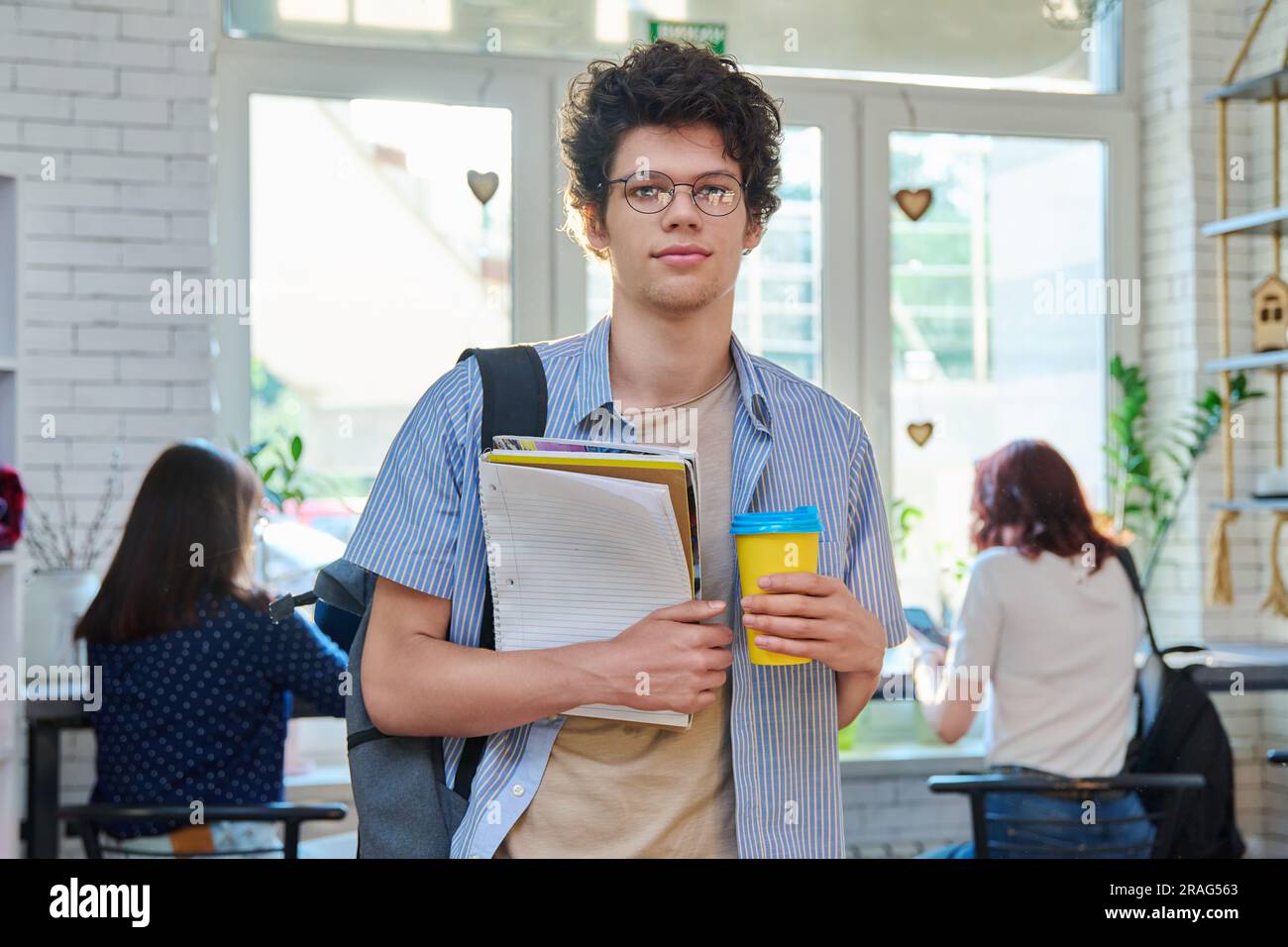 Male student with takeaway coffee in college coffee shop Stock Photo ...