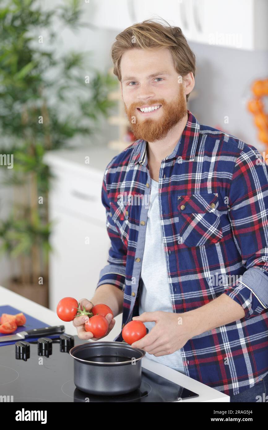 view of man cooking food in pot at kitchen Stock Photo - Alamy