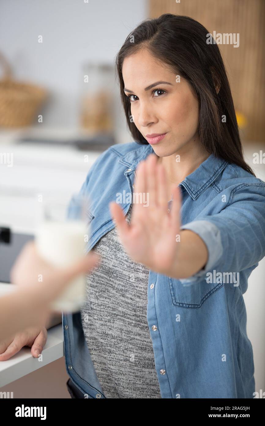 determined woman refusing a glass of cold milk Stock Photo - Alamy