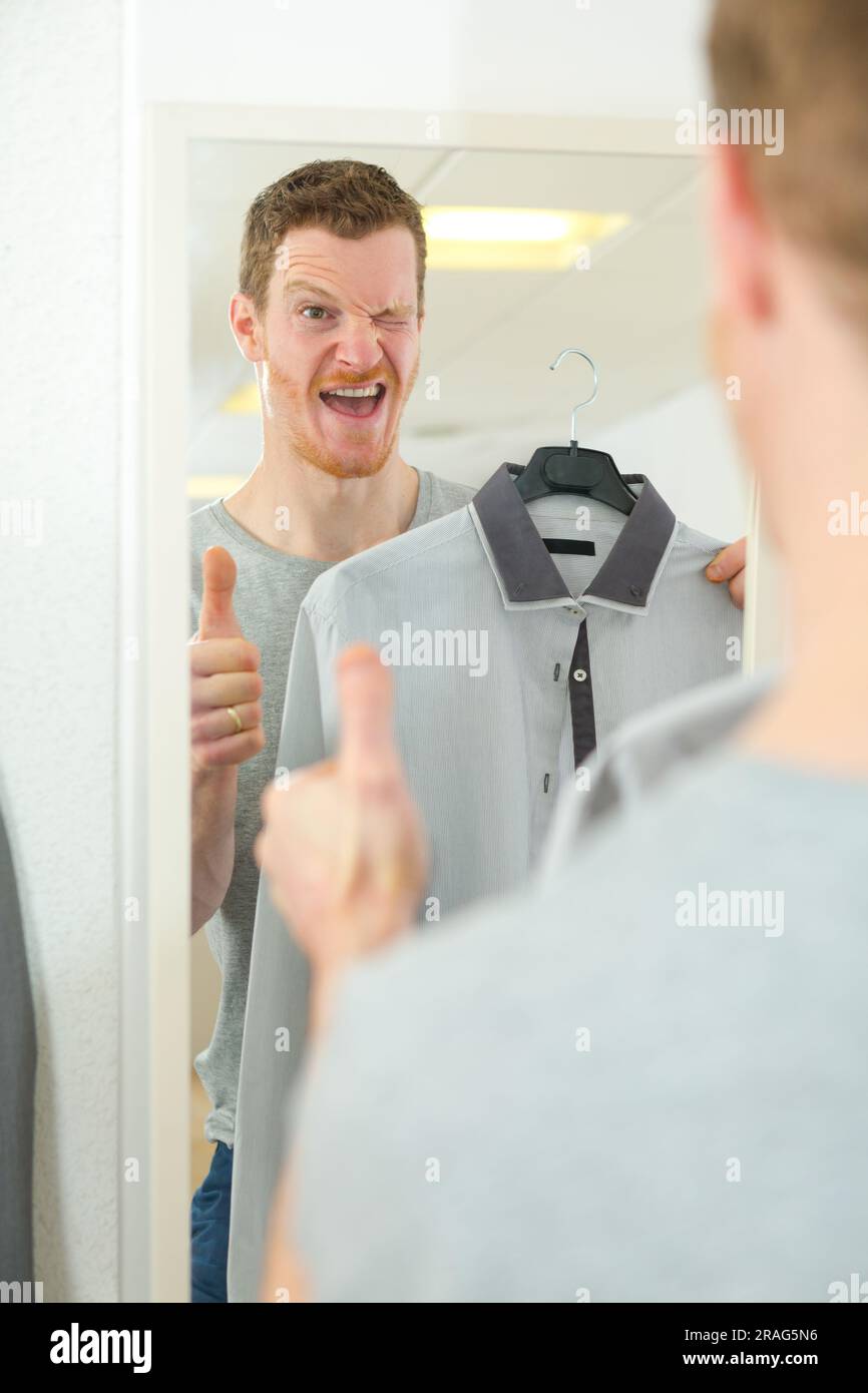 man looking at himself on the mirror Stock Photo - Alamy