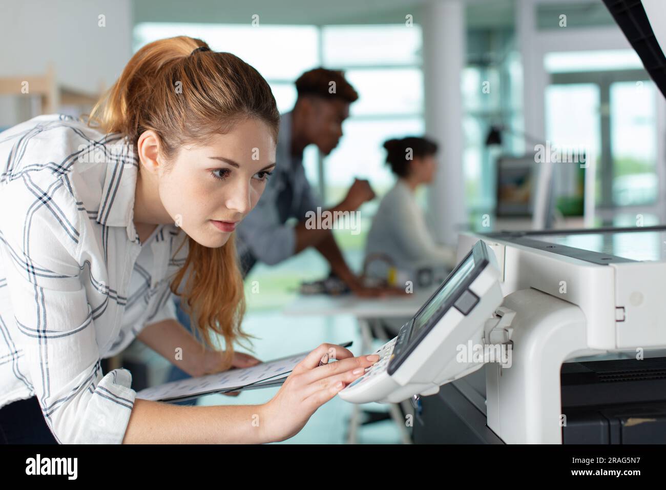 Female technician checking printer hi-res stock photography and images ...