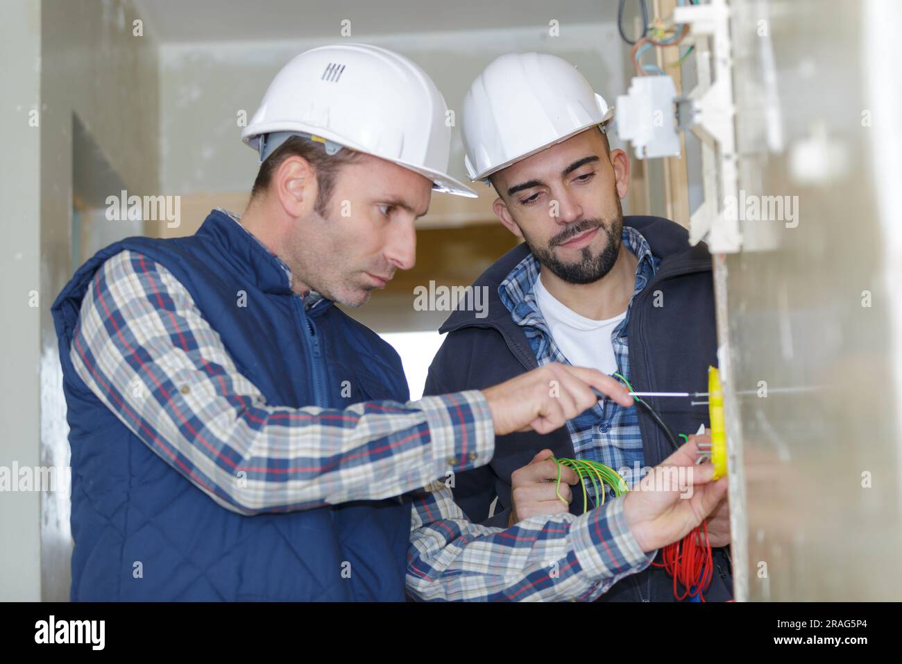electrician workers on electric power switch in fuse board Stock Photo ...