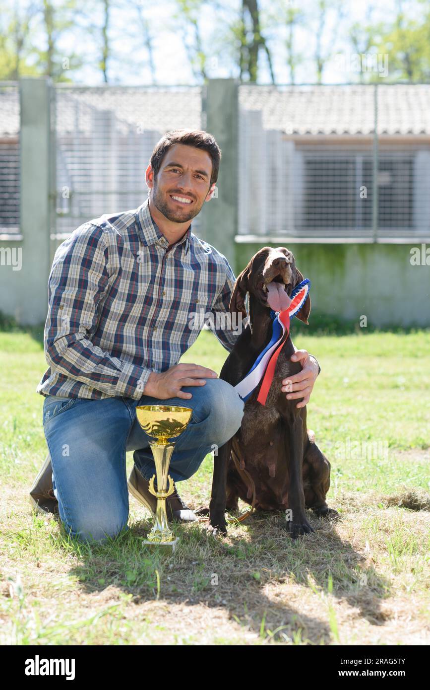 dog owner and winner cup bow Stock Photo - Alamy