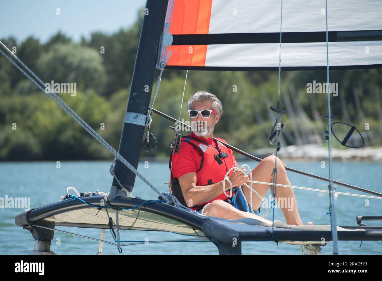 a sailing man pulling ropes Stock Photo - Alamy