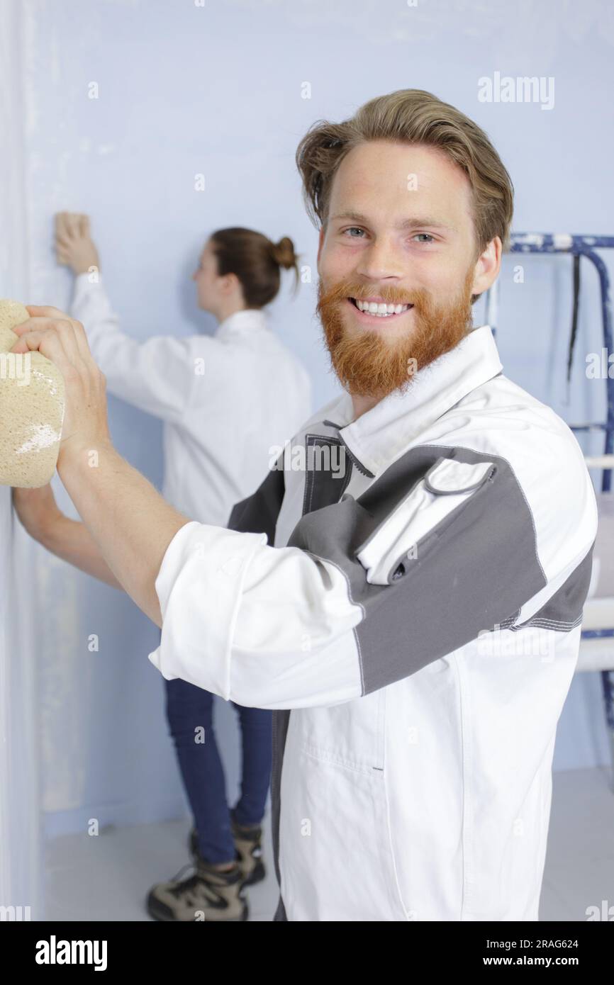professional man with sponge float plastering white wall Stock Photo ...