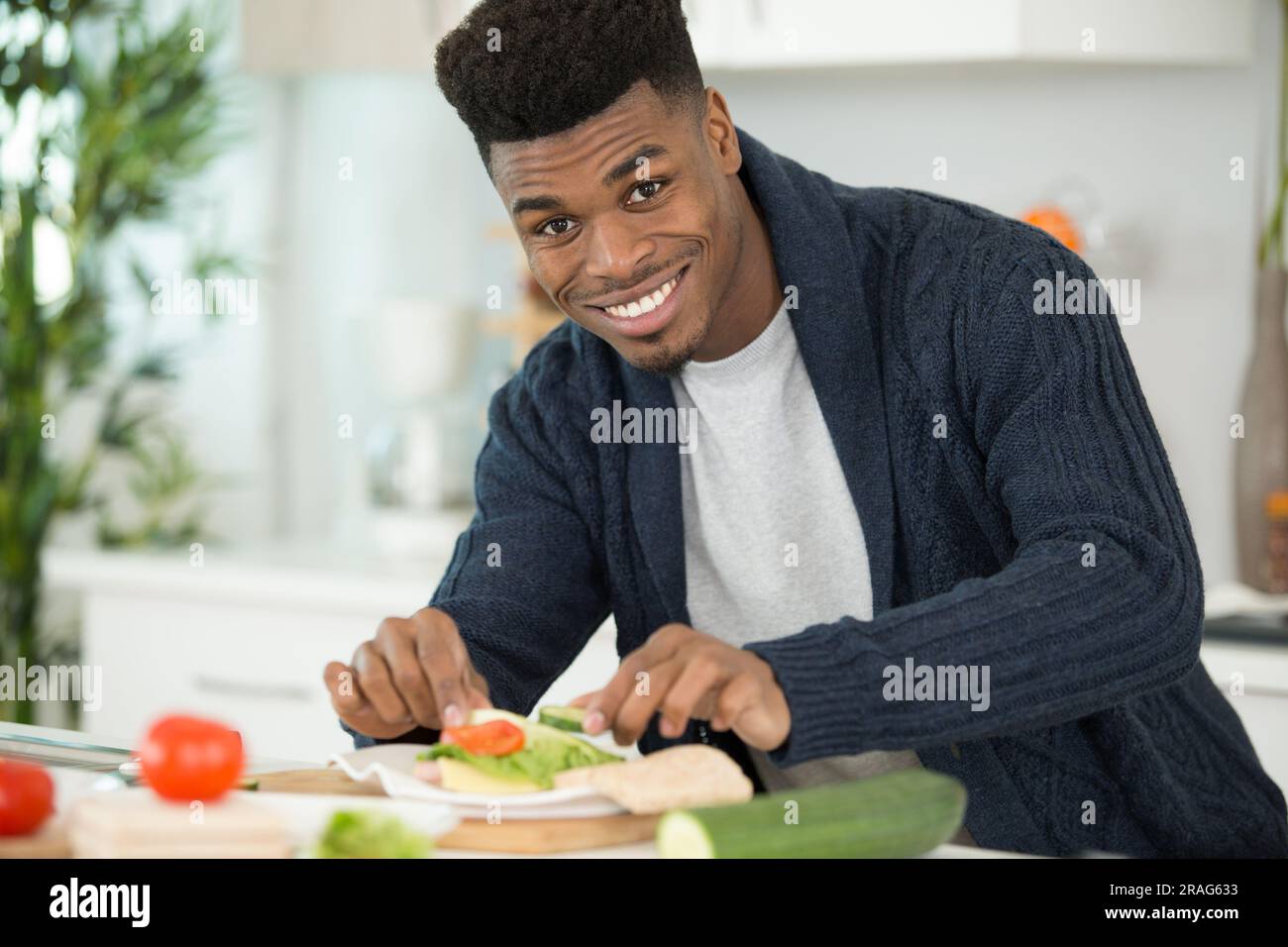 man at home making a sandwich Stock Photo - Alamy