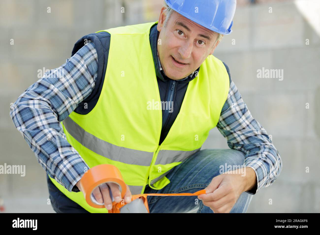 male construction worker in safety helmet near measuring pipes Stock ...