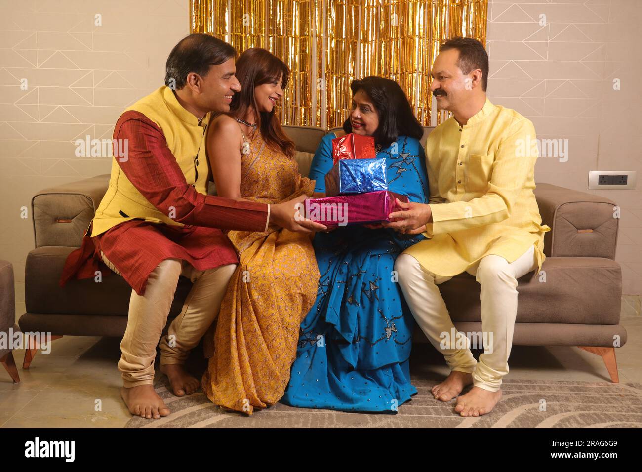 Happy Indian family enjoying the festive season on Diwali. Giving ...