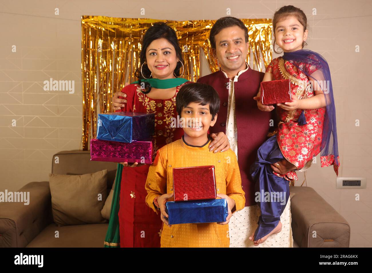 Happy Indian family enjoying the festive season on Diwali. Giving ...