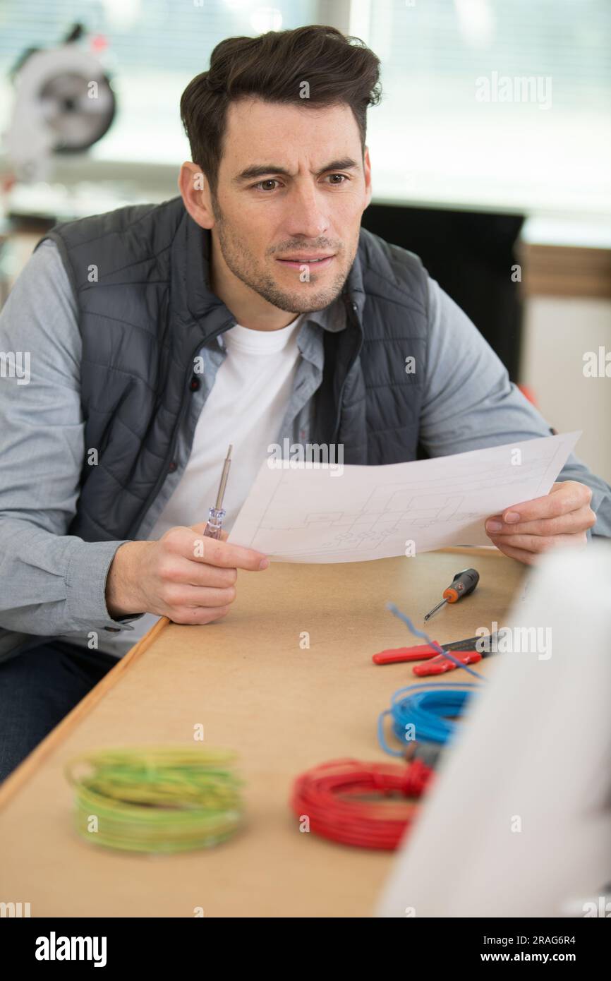 young man checking machine equipment at store factory Stock Photo - Alamy