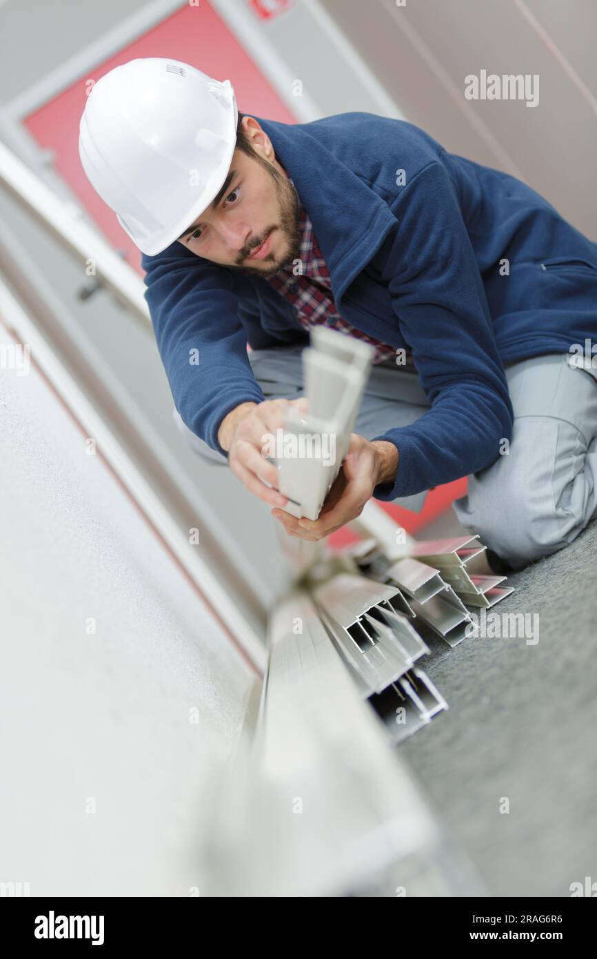 worker carrying steel wire Stock Photo - Alamy
