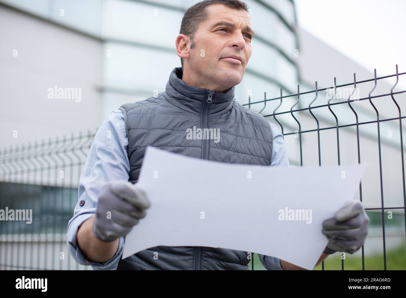 home builder looks at plans for new home Stock Photo - Alamy