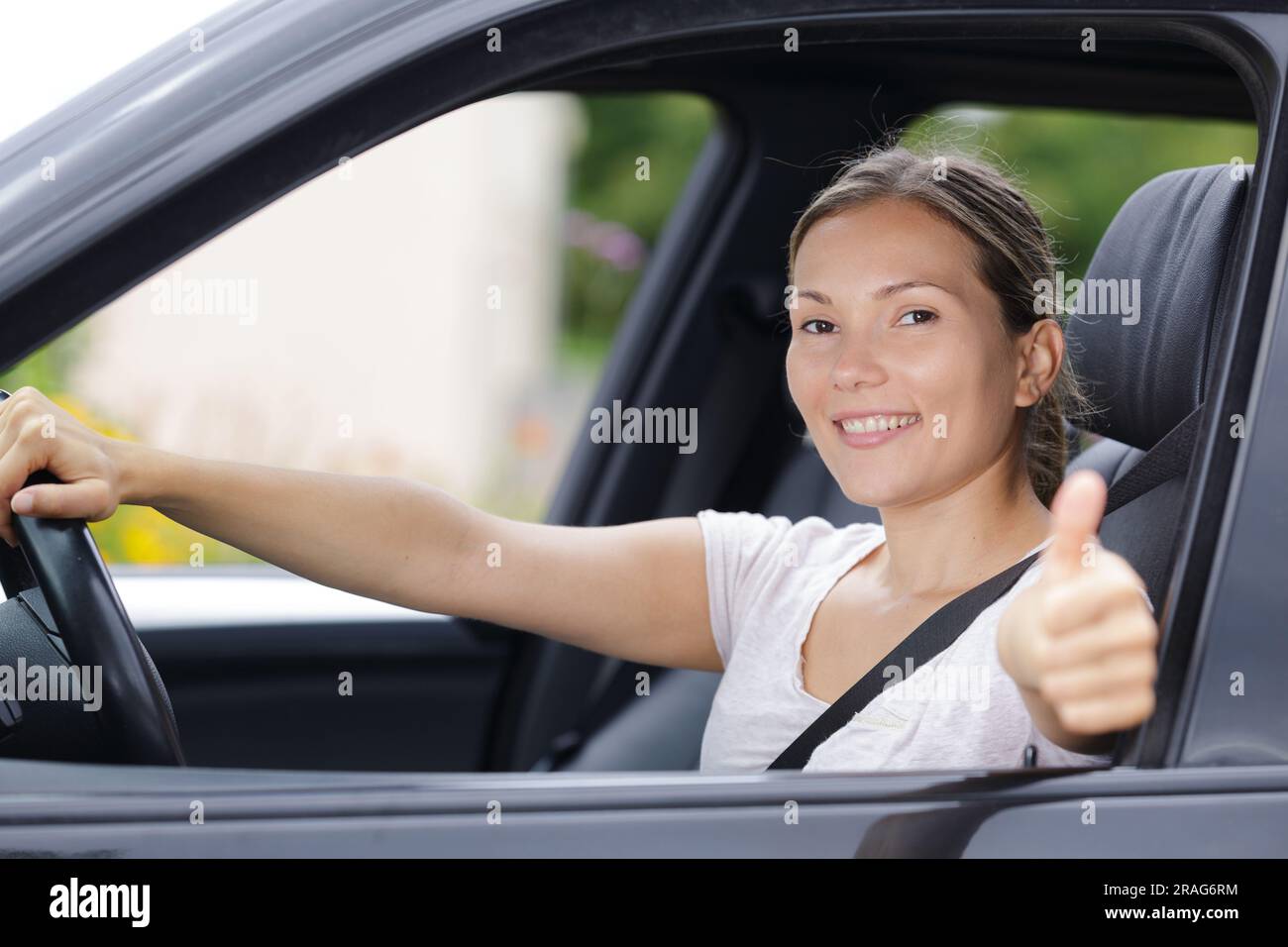 female driver showing thumbs up Stock Photo - Alamy