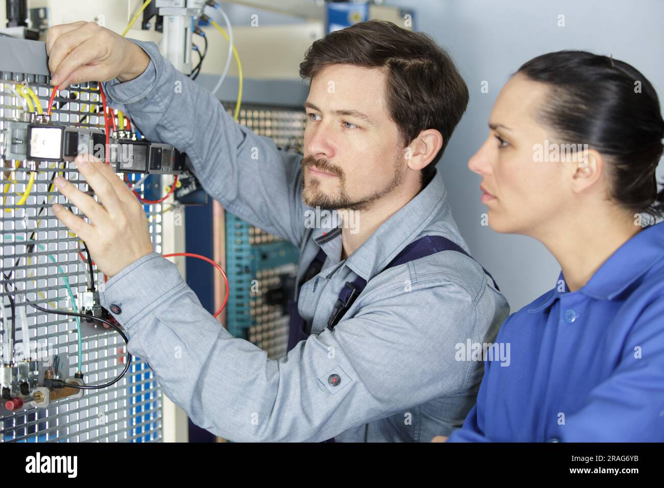 workers working with cables in factory Stock Photo - Alamy