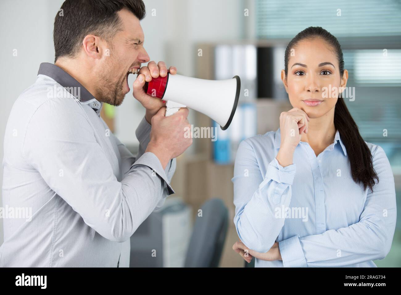 angry businessman using a megaphone Stock Photo - Alamy