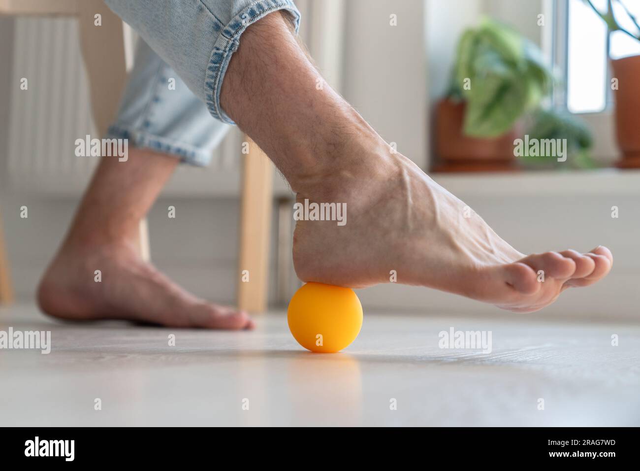 Man using silicone ball for foot massage doing prevention exercise to ...