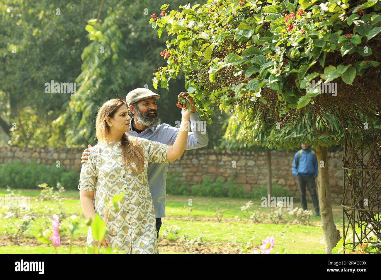 Aged Indian couple having a good romantic time in the green park. They ...