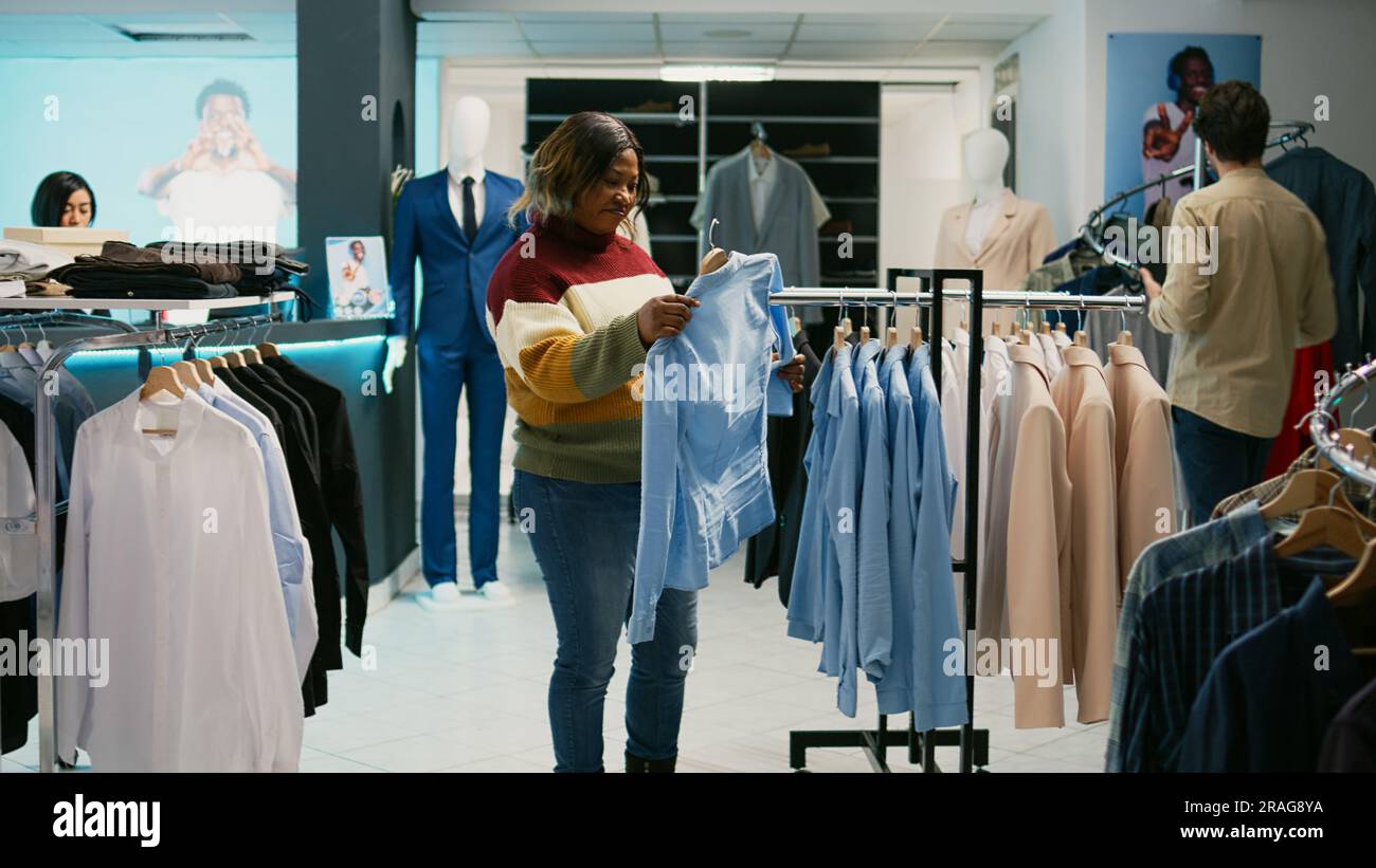 Diverse women talking about fashion brands in retail shop, client and ...