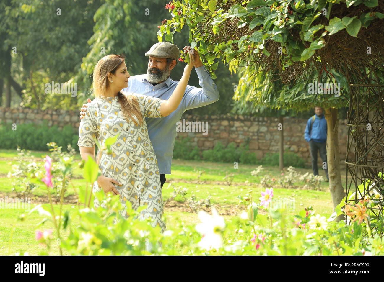 Aged Indian couple having a good romantic time in the green park. They ...