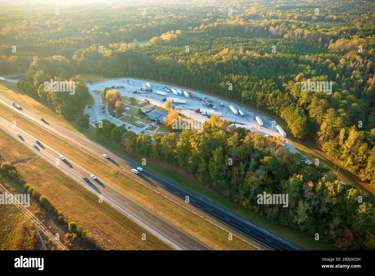 Aerial view of big rest area near busy american freeway with fast ...