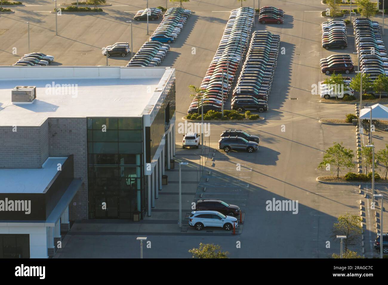 Aerial view of dealership parking lot with many brand new cars for sale ...
