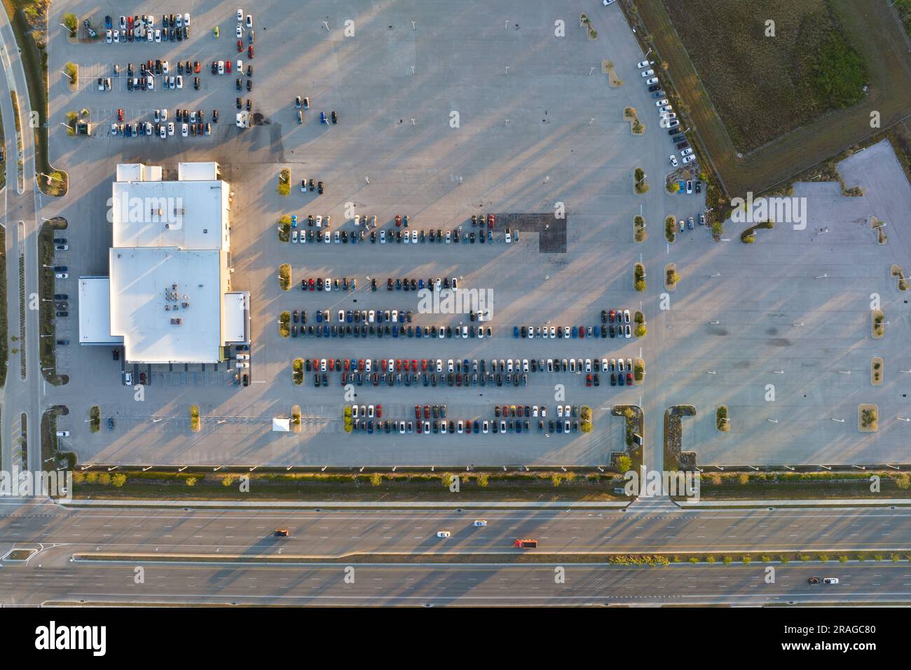 Aerial view of dealership parking lot with many brand new cars for sale ...