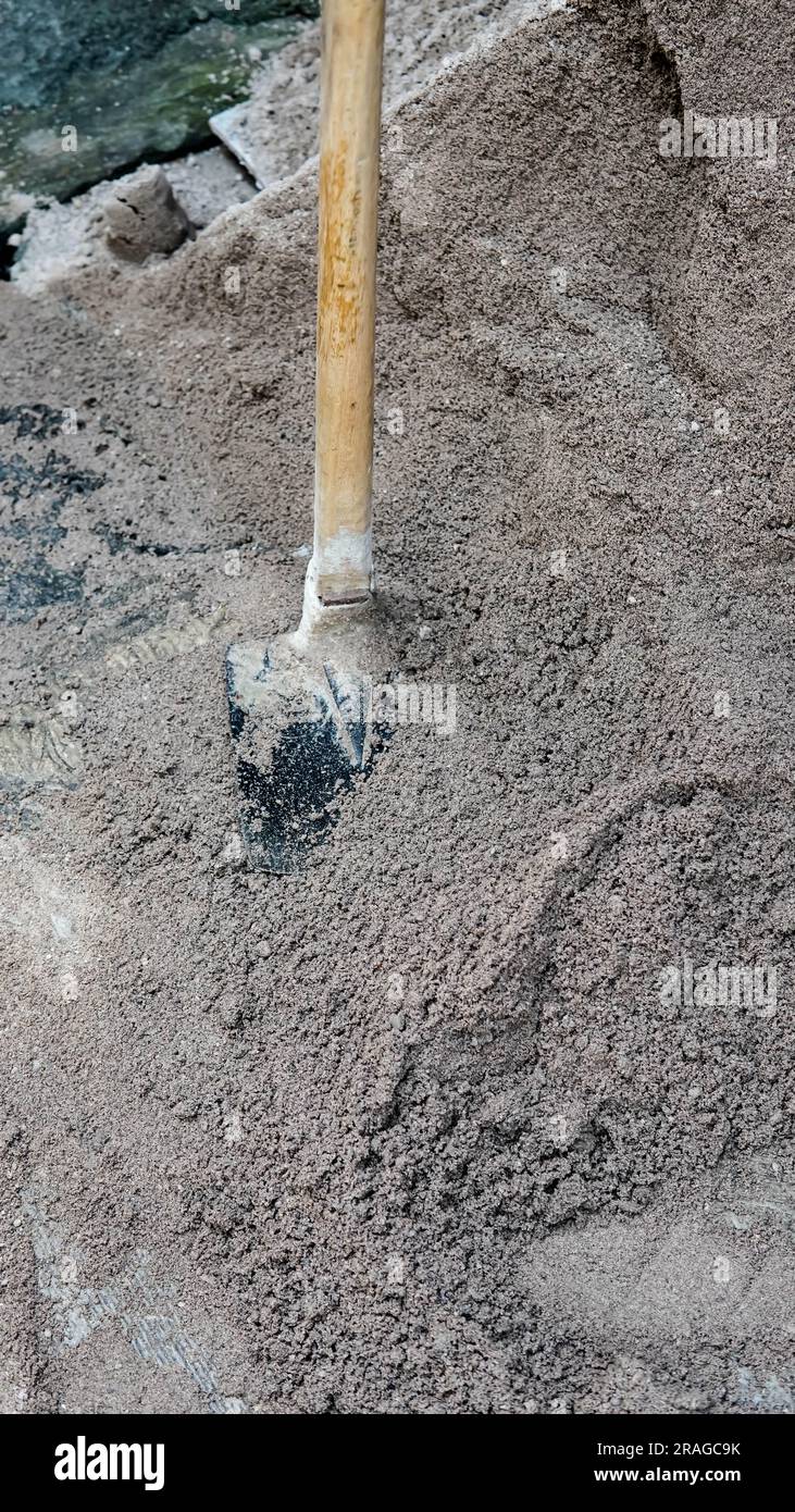 A pile of sand poured into a meadow for construction Stock Photo - Alamy