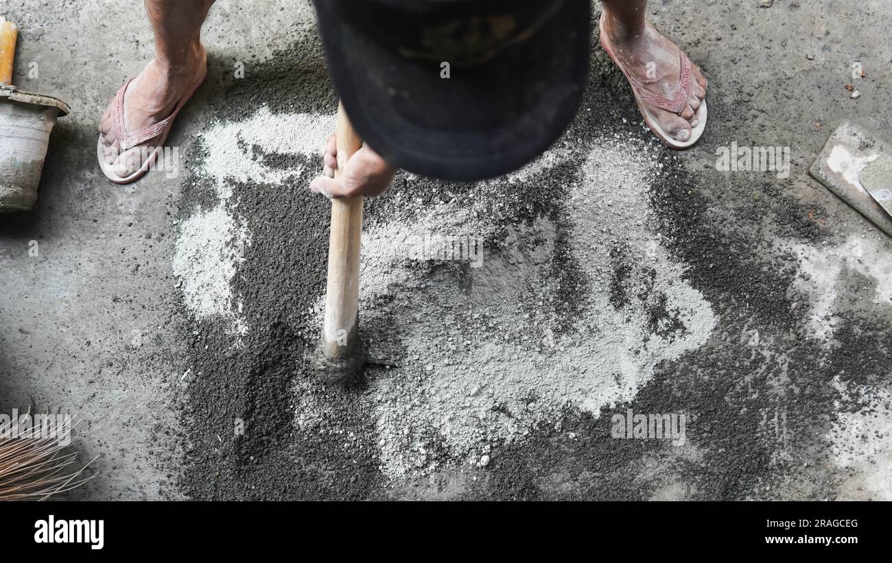 Asian worker using hoe for mixing cement power with sand Stock Photo ...